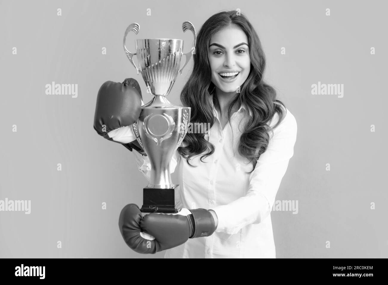 Woman in boxing gloves hold champion winner cup, trophy. Excited win ...