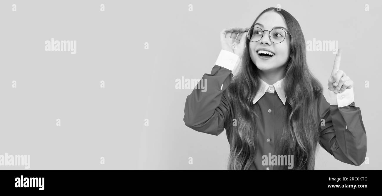 Clever idea. Clever girl in eyeglasses yellow background. School age ...