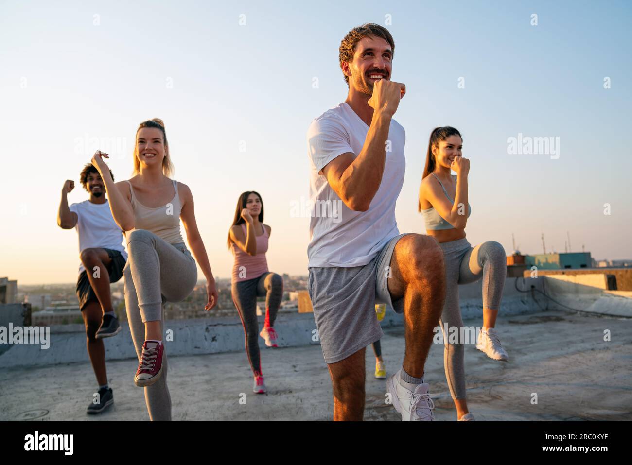 Group of fit healthy friends, people exercising together outdoor Stock ...