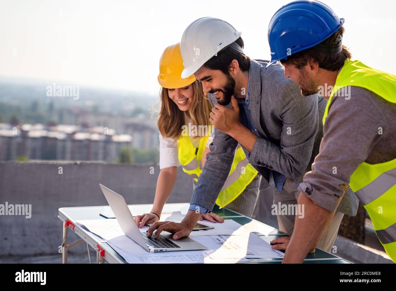 Team of architects people in group on construciton site check documents ...