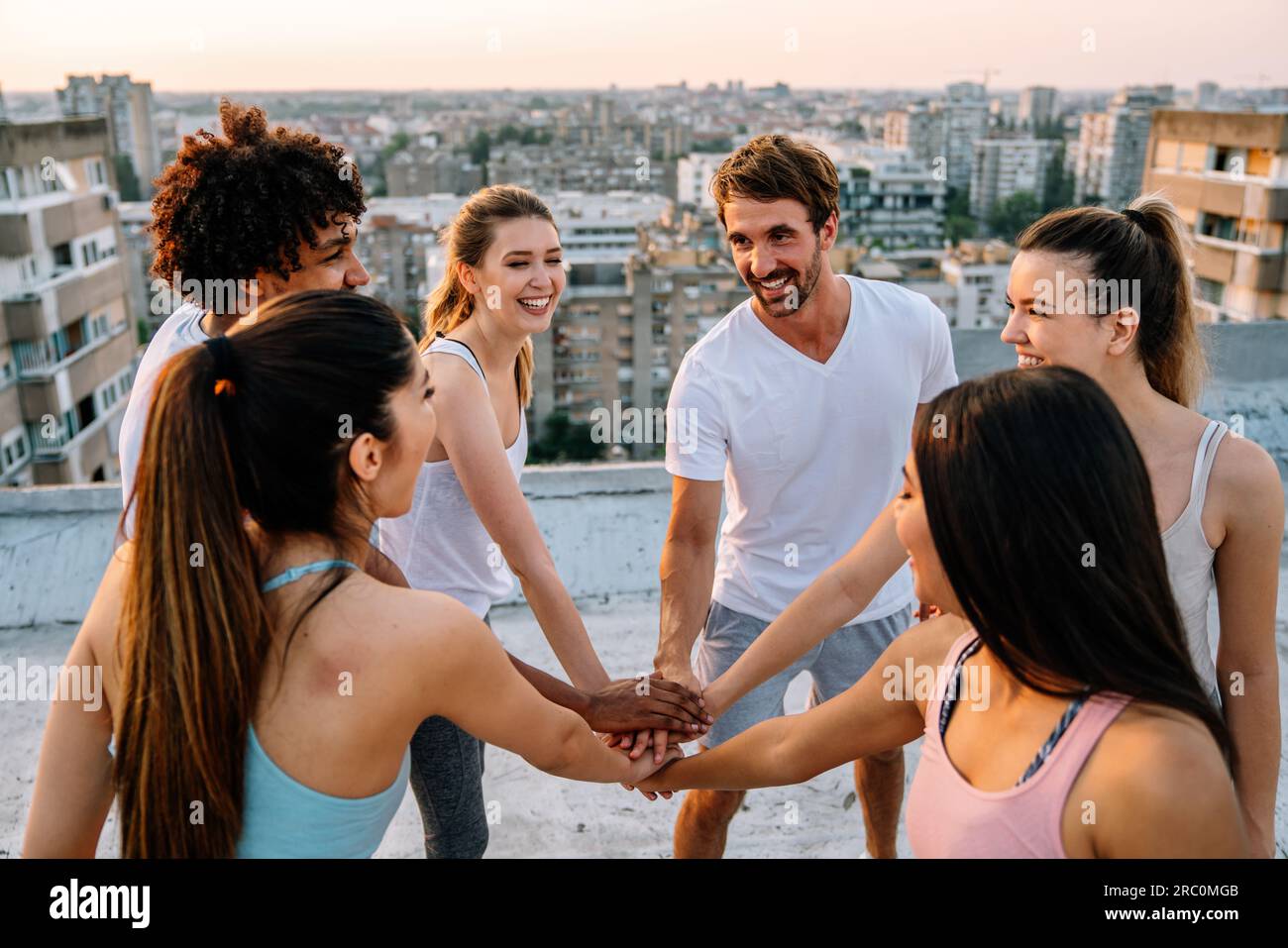 Group of happy fit people friends exercising together outdoor to stay ...
