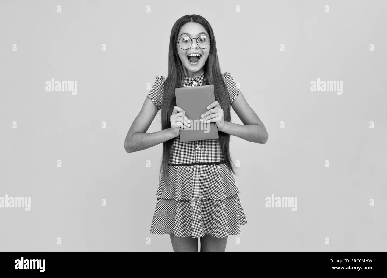 Amazed teen girl. Schoolgirl with copy book posing on isolated ...
