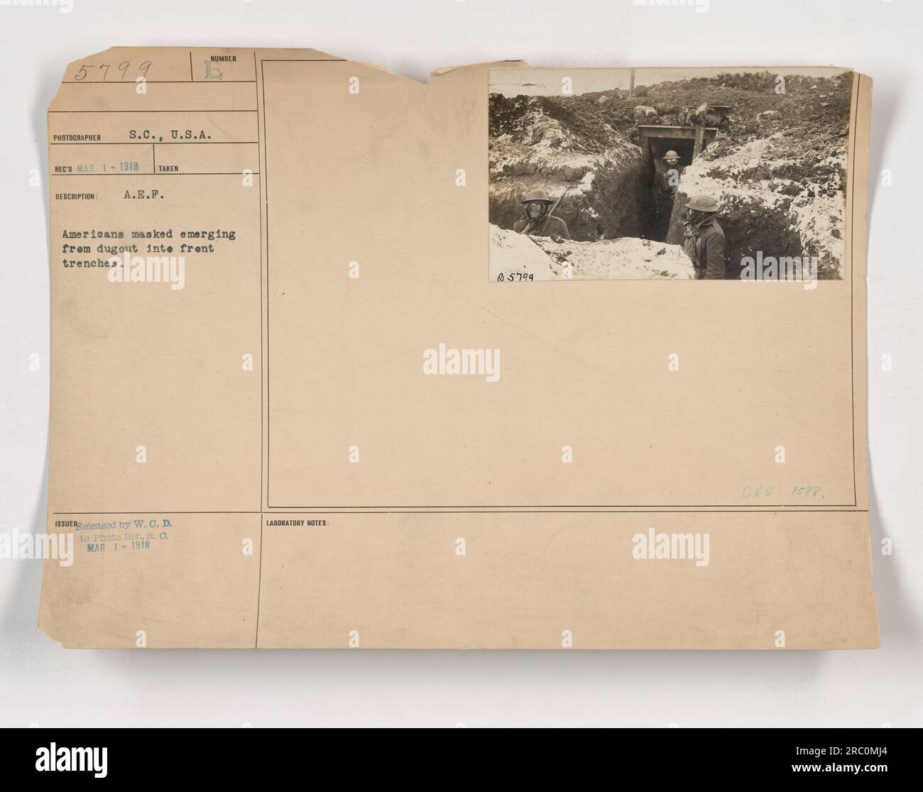 American soldiers emerge from a dugout and don gas masks as they ...