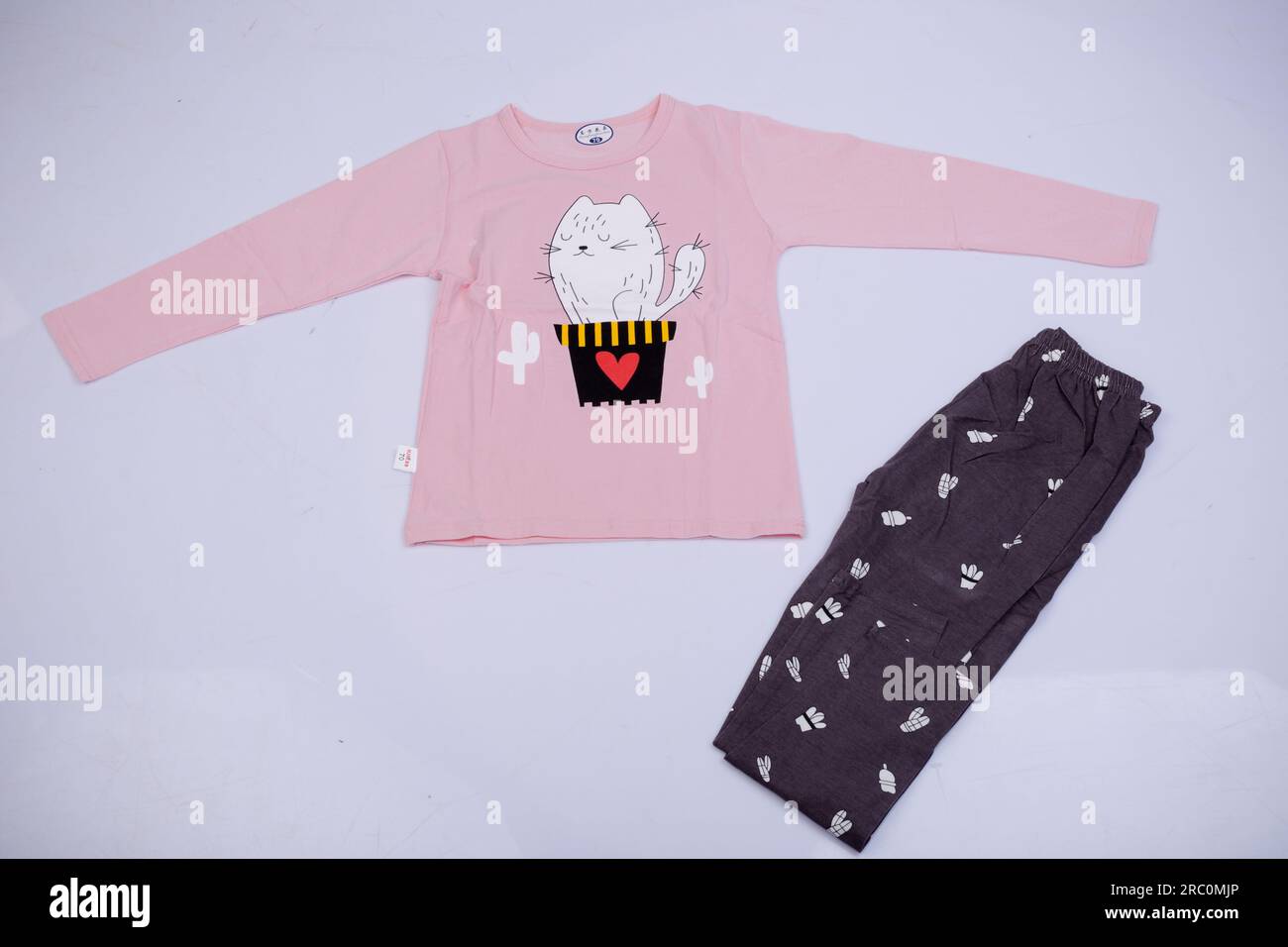 Clothe cloth small kids children outfits display Stock Photo - Alamy