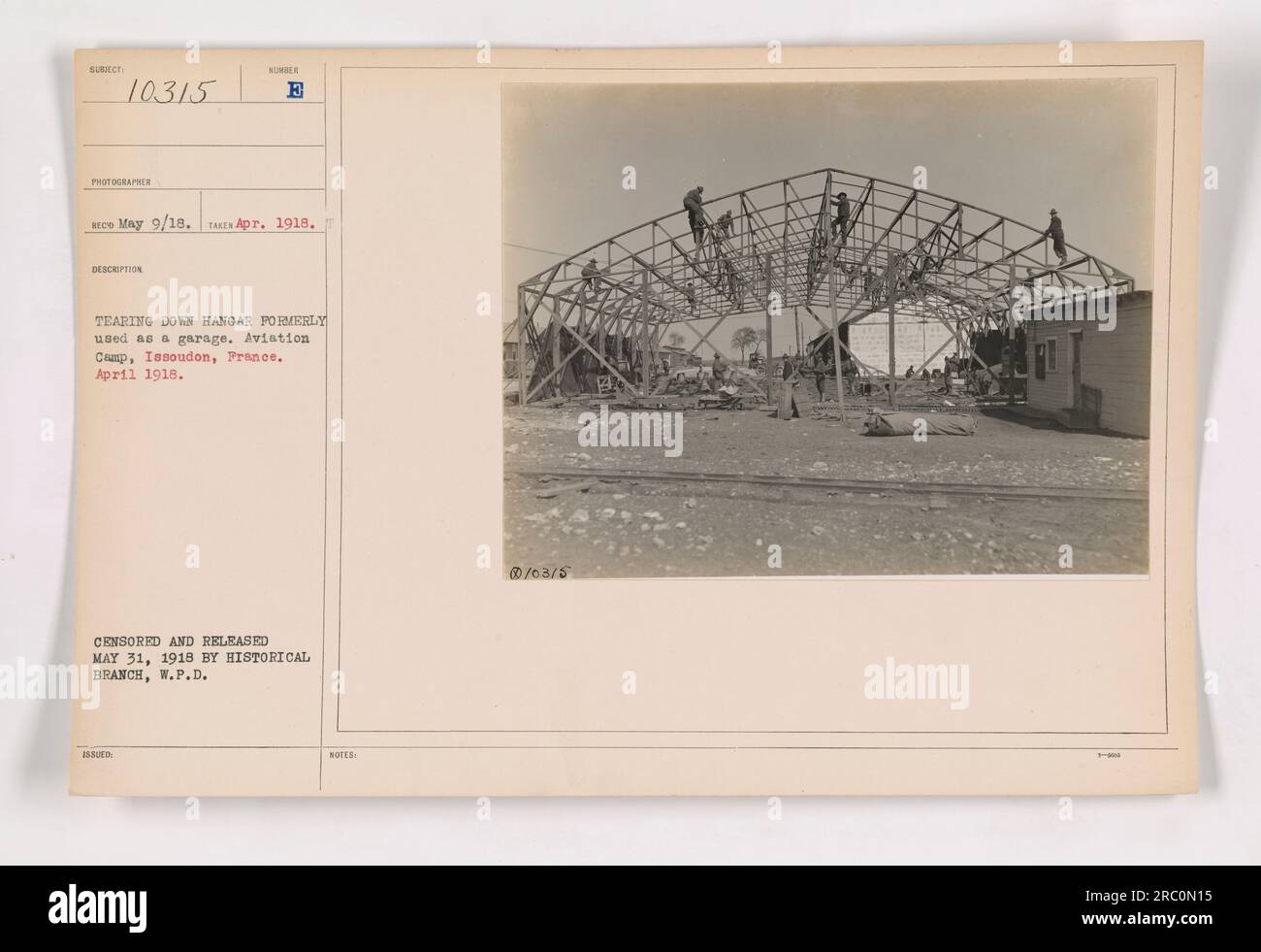 Soldiers tear down a hangar that was previously used as a garage at the Aviation Camp in ...