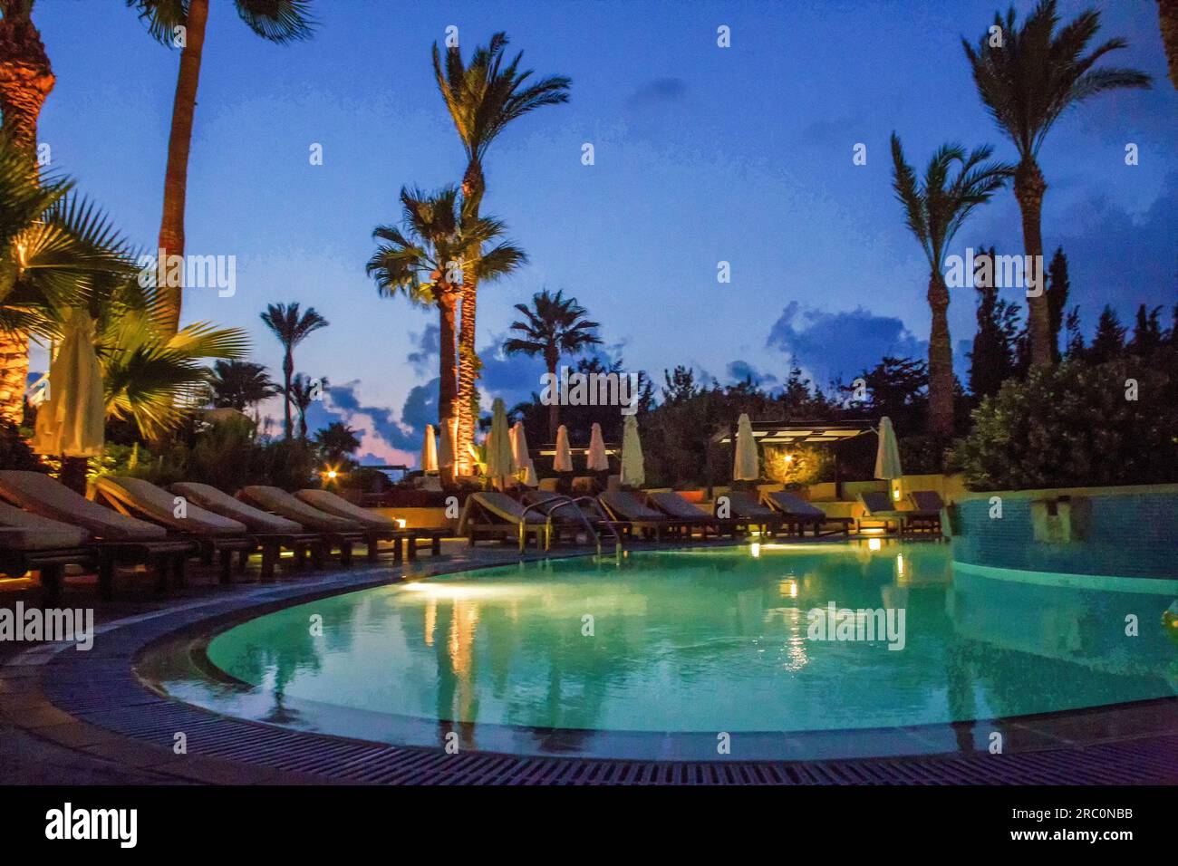 Fantastic night view on pool in twilights behind some pavilion ( bar ...