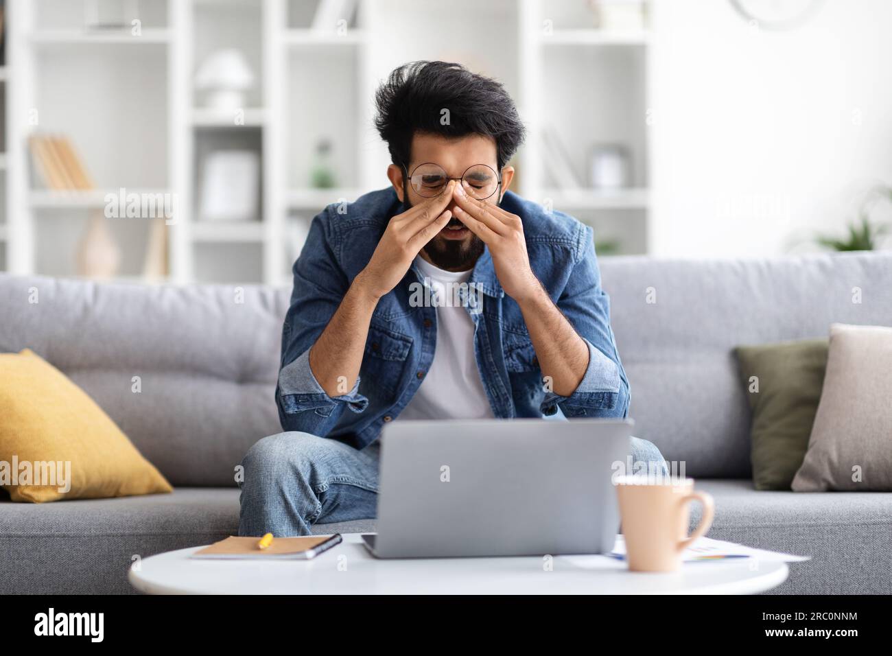 Stressed Young Indian Man Feeling Tired While Work With Laptop At Home ...