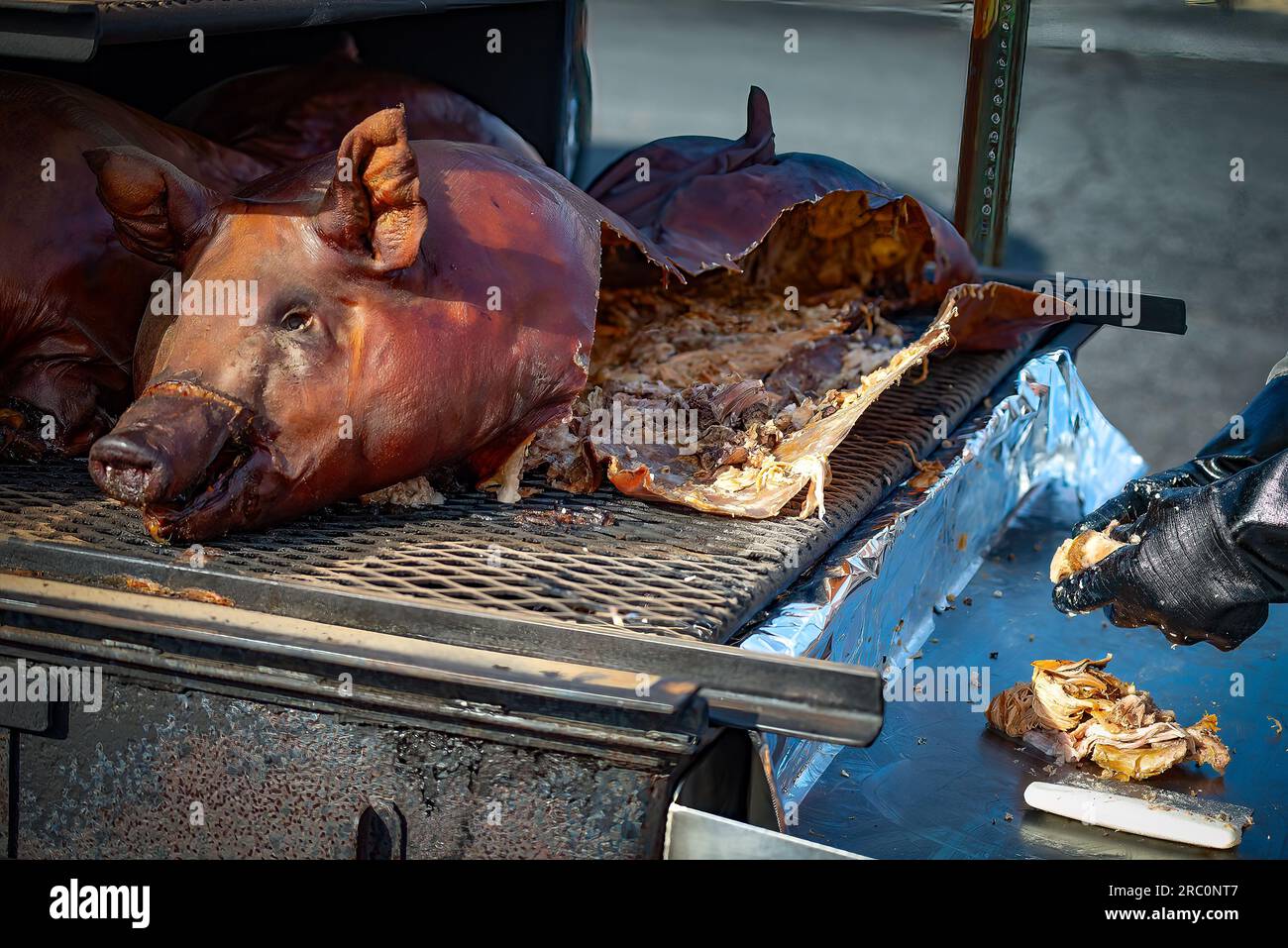 BBQ grill, roasting of whole pig. country fair Stock Photo - Alamy