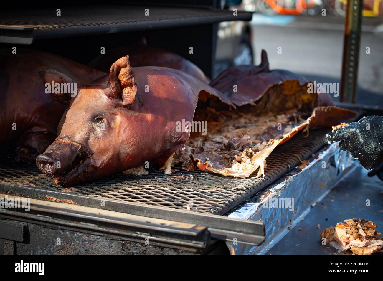 BBQ grill, roasting of whole pig. country fair Stock Photo - Alamy
