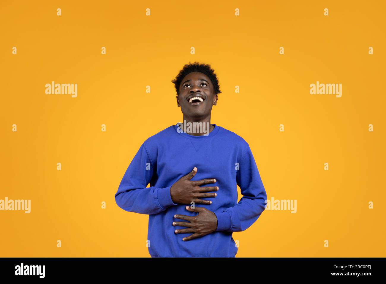 Joyful millennial black man laughing and looking up Stock Photo - Alamy