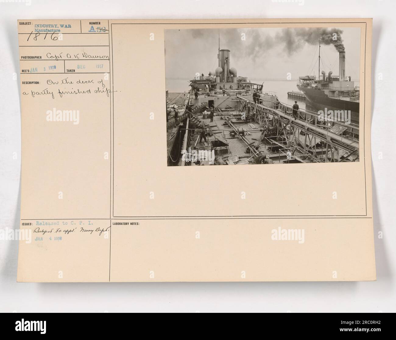 Workers are seen on the deck of a partly finished ship during World War ...
