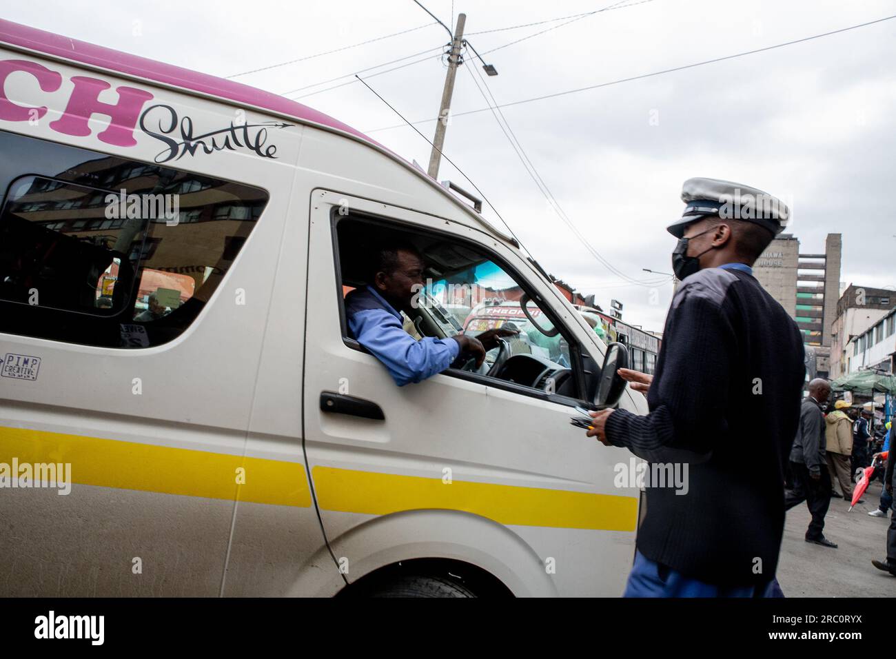 A traffic police officer takes control of motorists through the busy ...