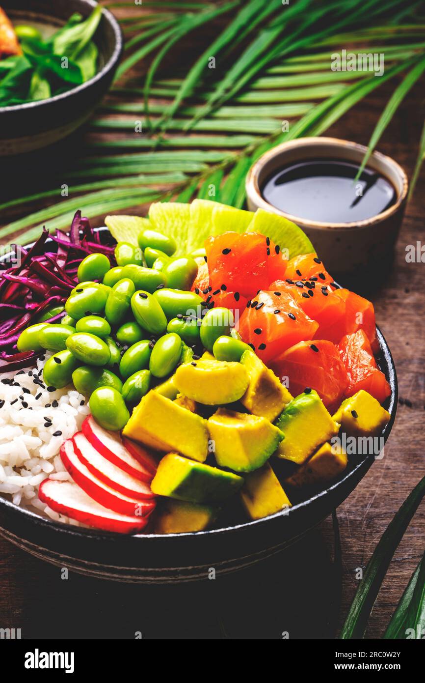 Poke bowl with salmon, avocado, radish, edamame beans, red cabbage and ...