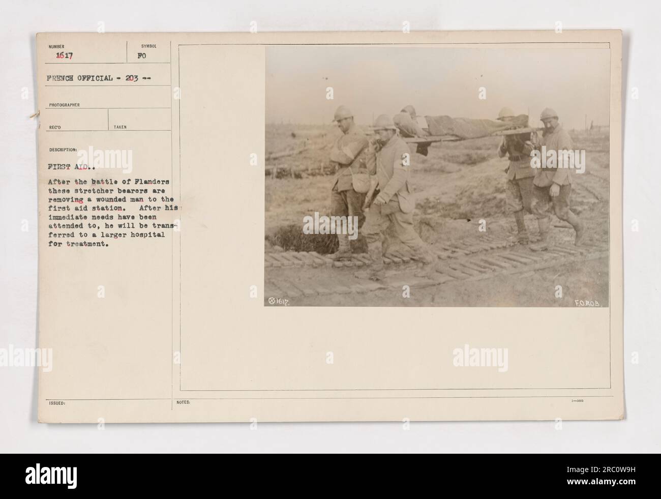 Stretcher bearers assisting in the transportation of a wounded soldier ...