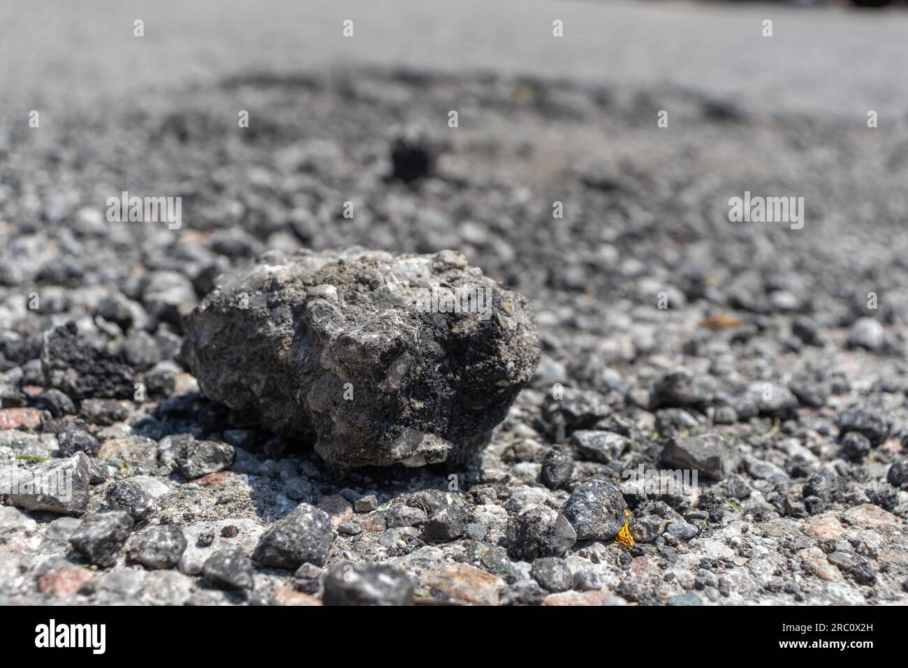 Small rock on road - rough texture close up background. Taken in ...