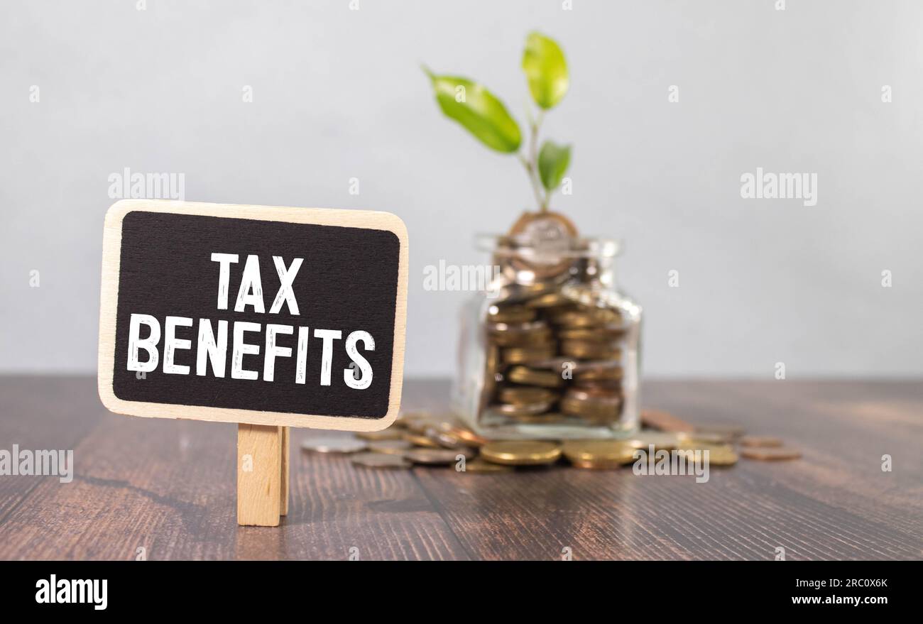 On a white tablet the inscription TAX BENEFITS on the background of ...