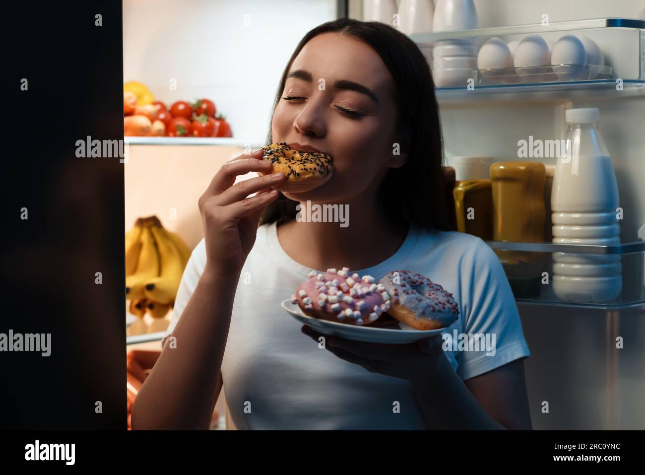 Woman eating donut hi-res stock photography and images - Alamy
