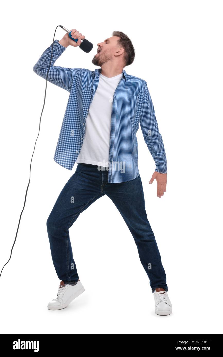 Handsome man with microphone singing on white background Stock Photo ...