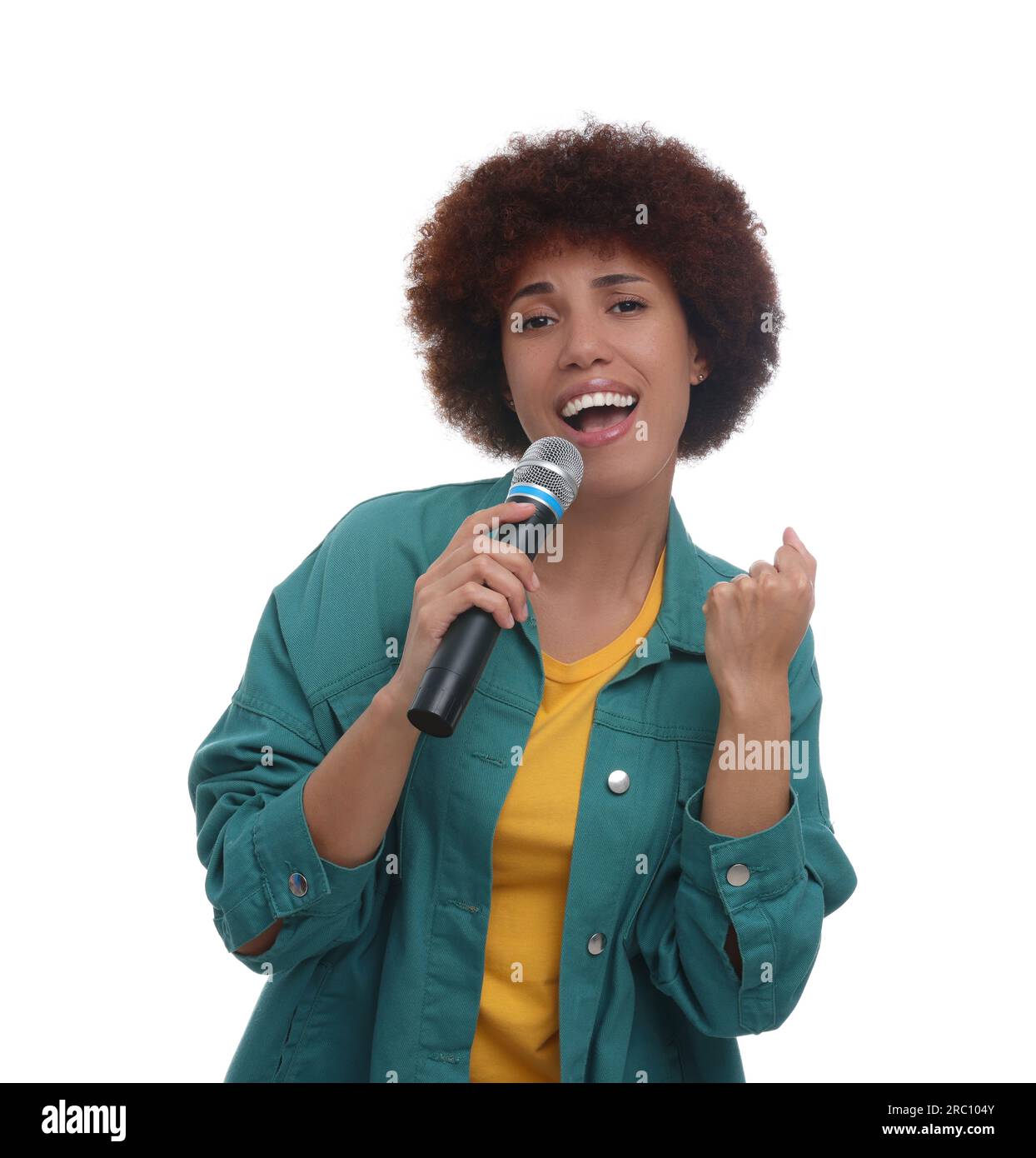 Curly young woman with microphone singing on white background Stock ...