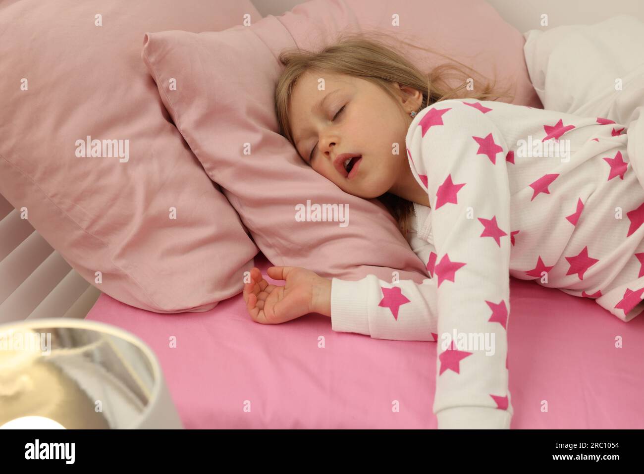Little girl snoring while sleeping in bed Stock Photo - Alamy