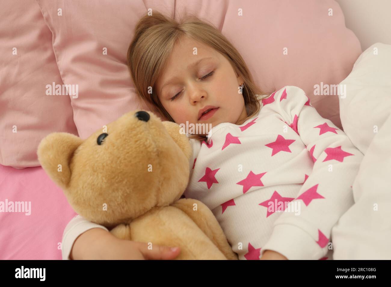Little girl snoring while sleeping in bed Stock Photo - Alamy