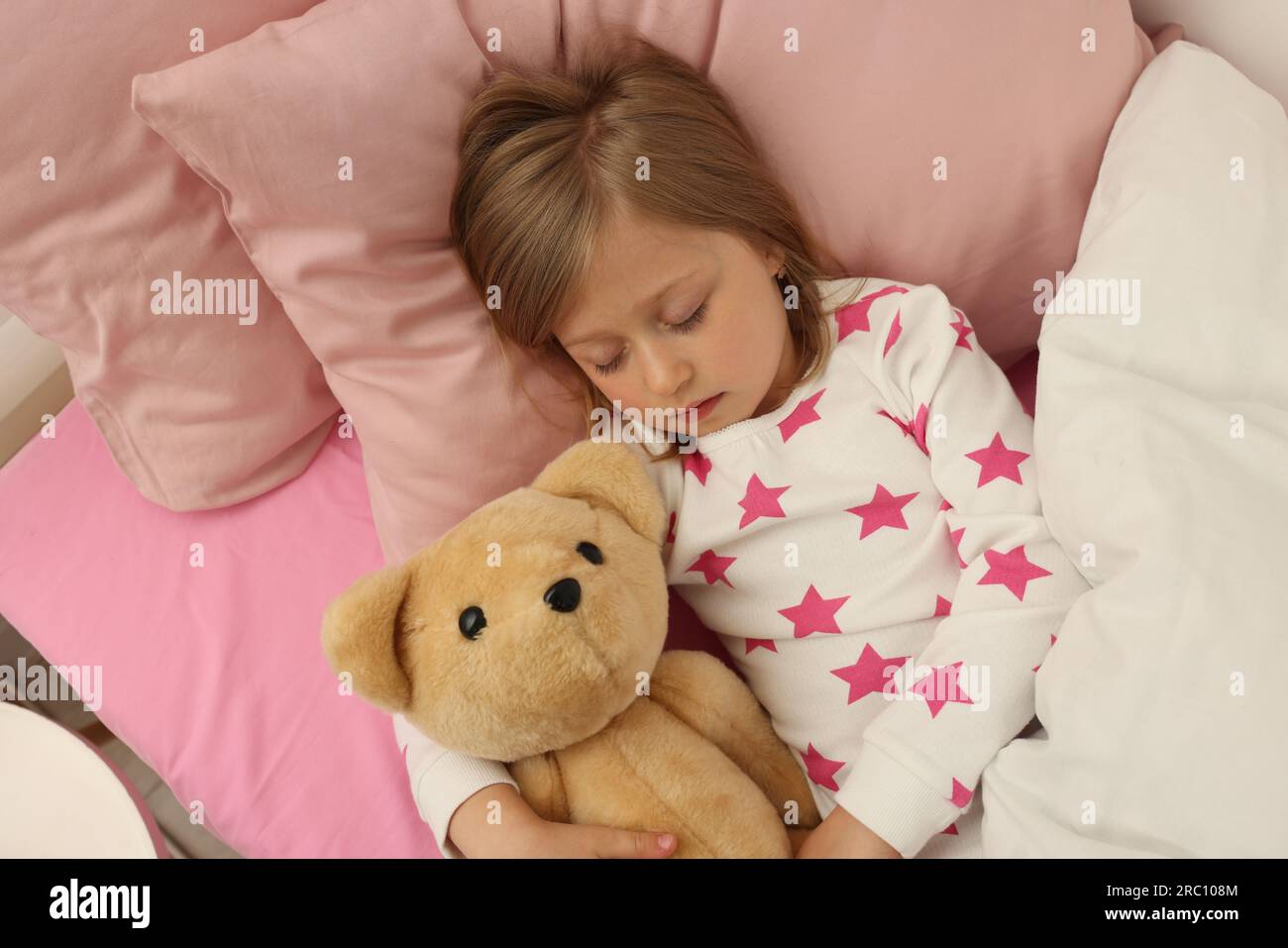 Little girl snoring while sleeping in bed, above view Stock Photo - Alamy