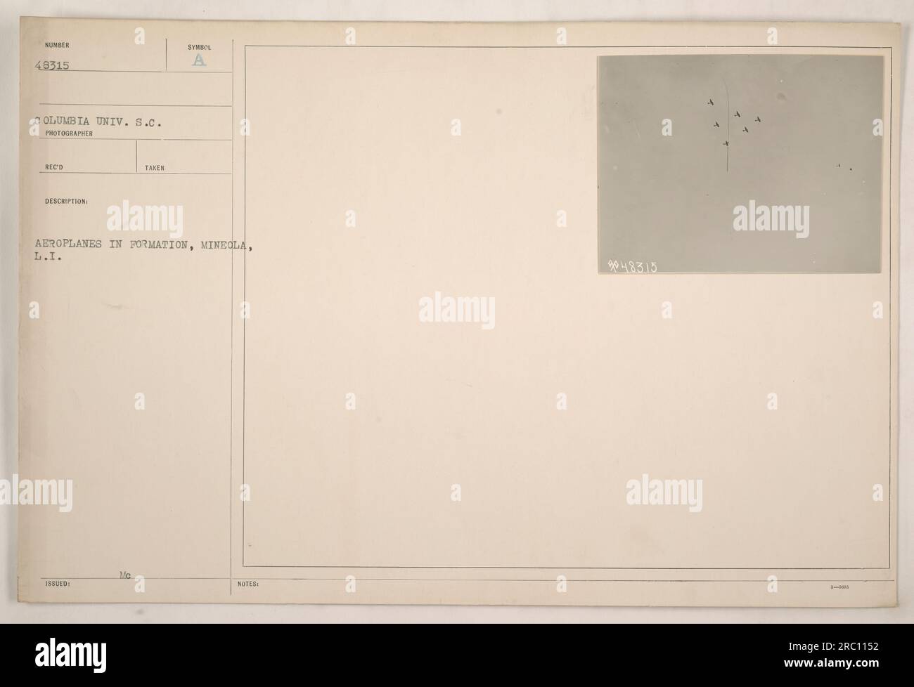 Aerial photograph showing a group of airplanes flying in formation over ...