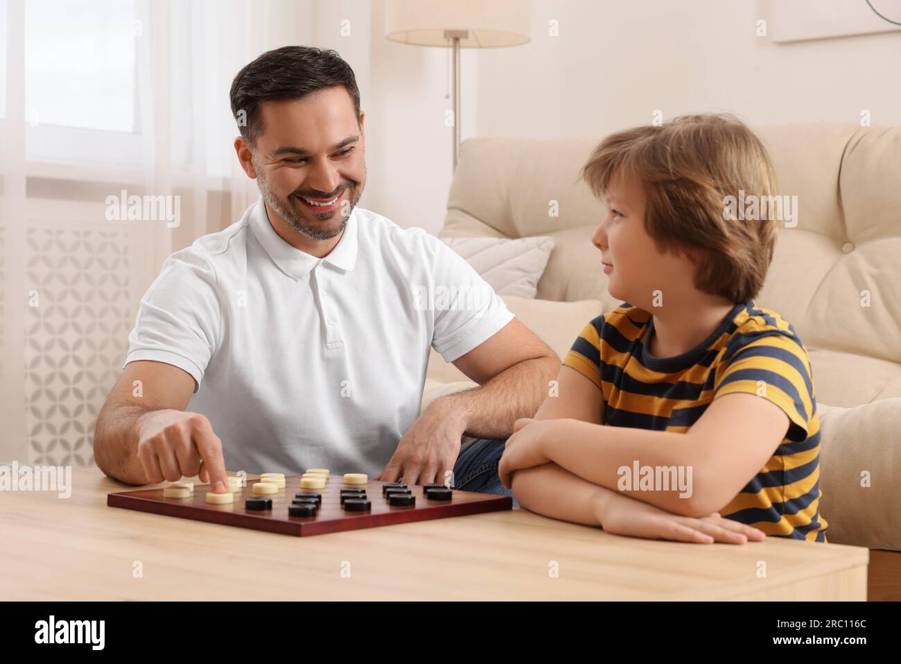 Smiling father playing board hi-res stock photography and images - Alamy