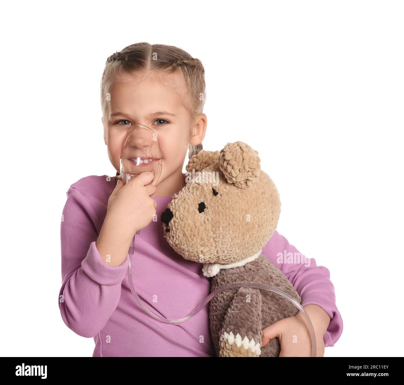 Little girl with toy bear using nebulizer for inhalation on white ...