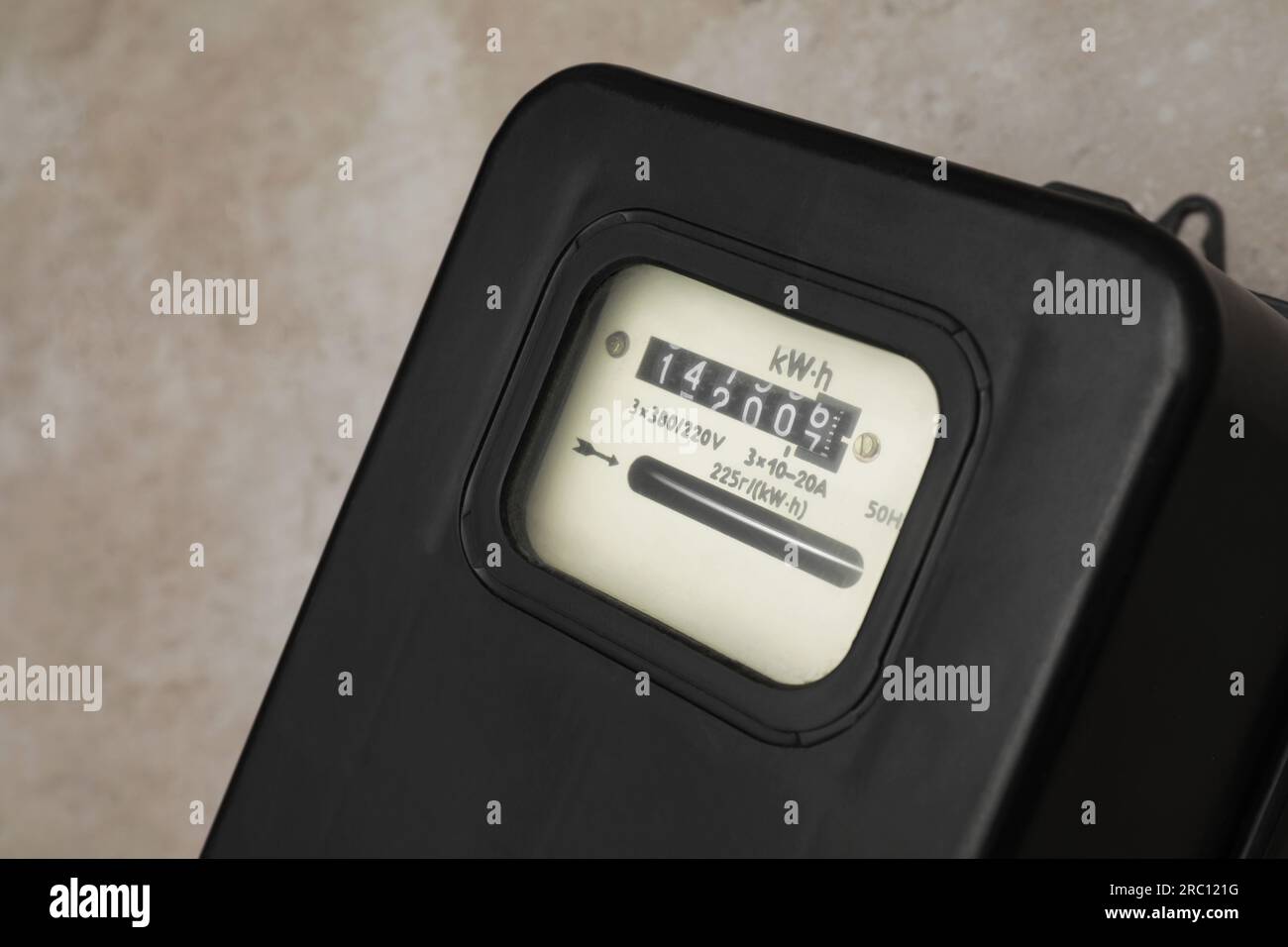 Black electric meter on grey background, closeup. Measuring device ...