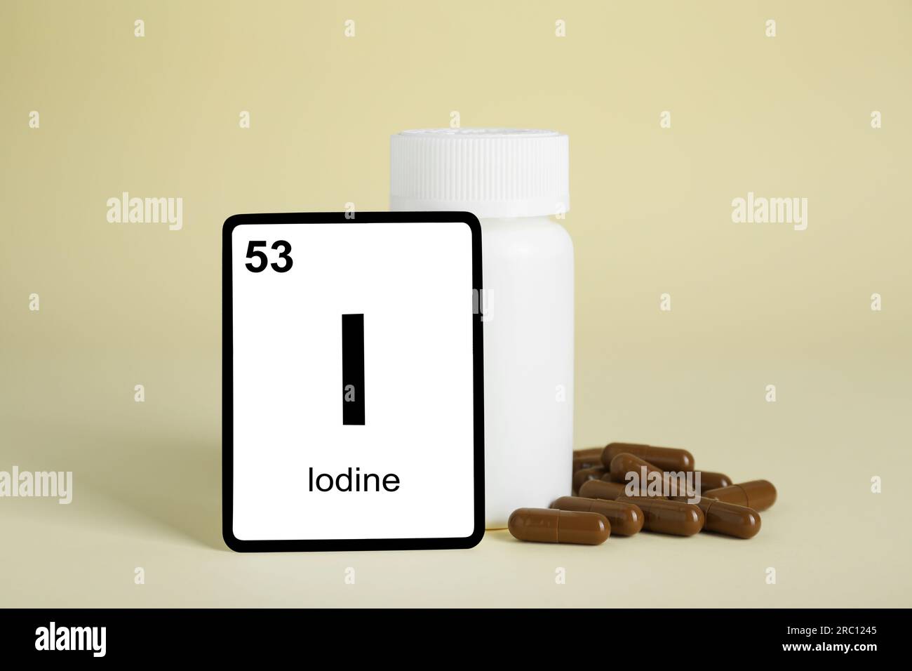 Card with iodine element, jar and pills on beige background Stock Photo ...