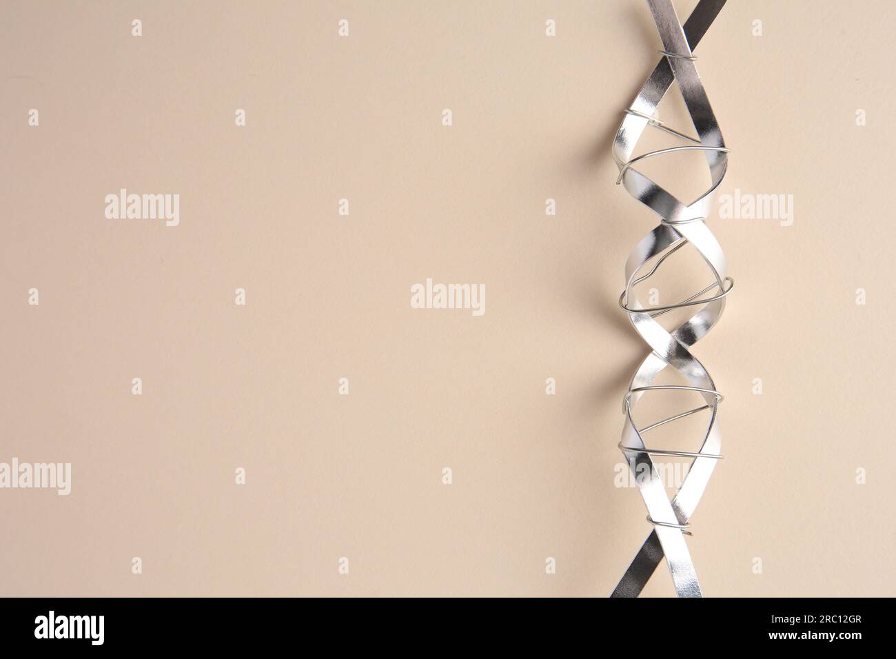 DNA molecular chain model made of metal on beige background, top view ...