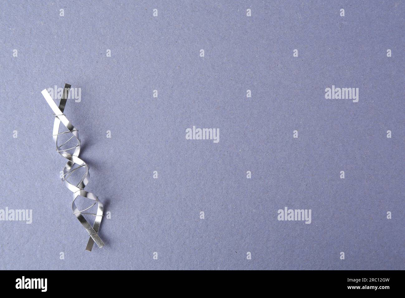 DNA molecular chain model made of metal on grey background, top view ...