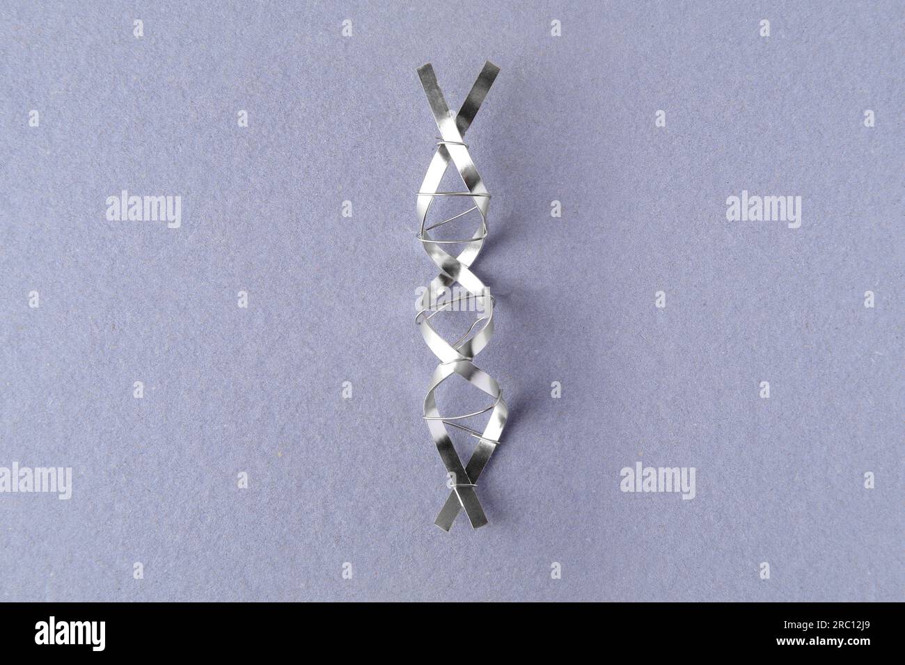 DNA molecular chain model made of metal on grey background, top view ...