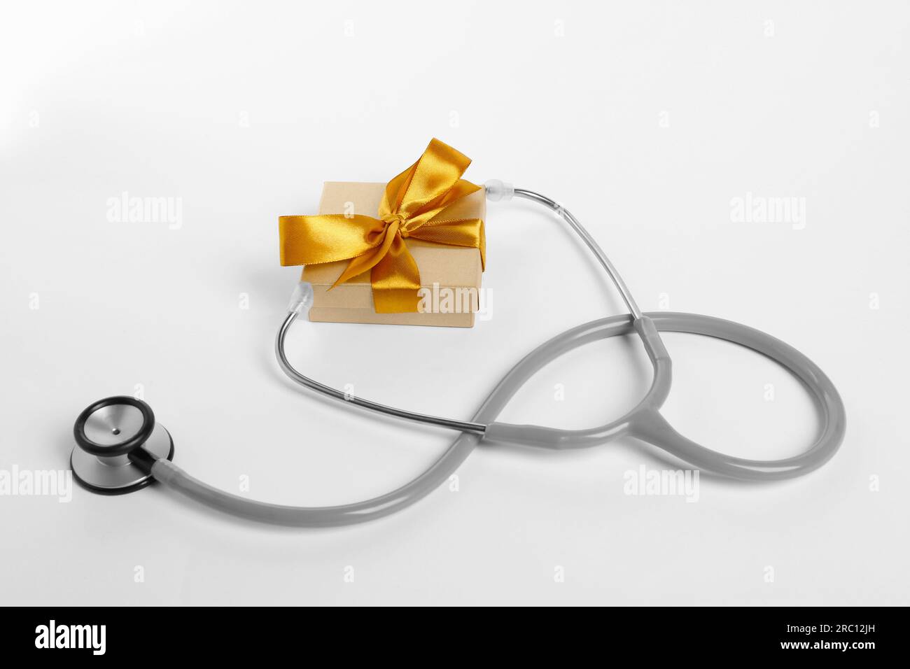 Stethoscope and gift box on white background. Happy Doctor's Day Stock ...