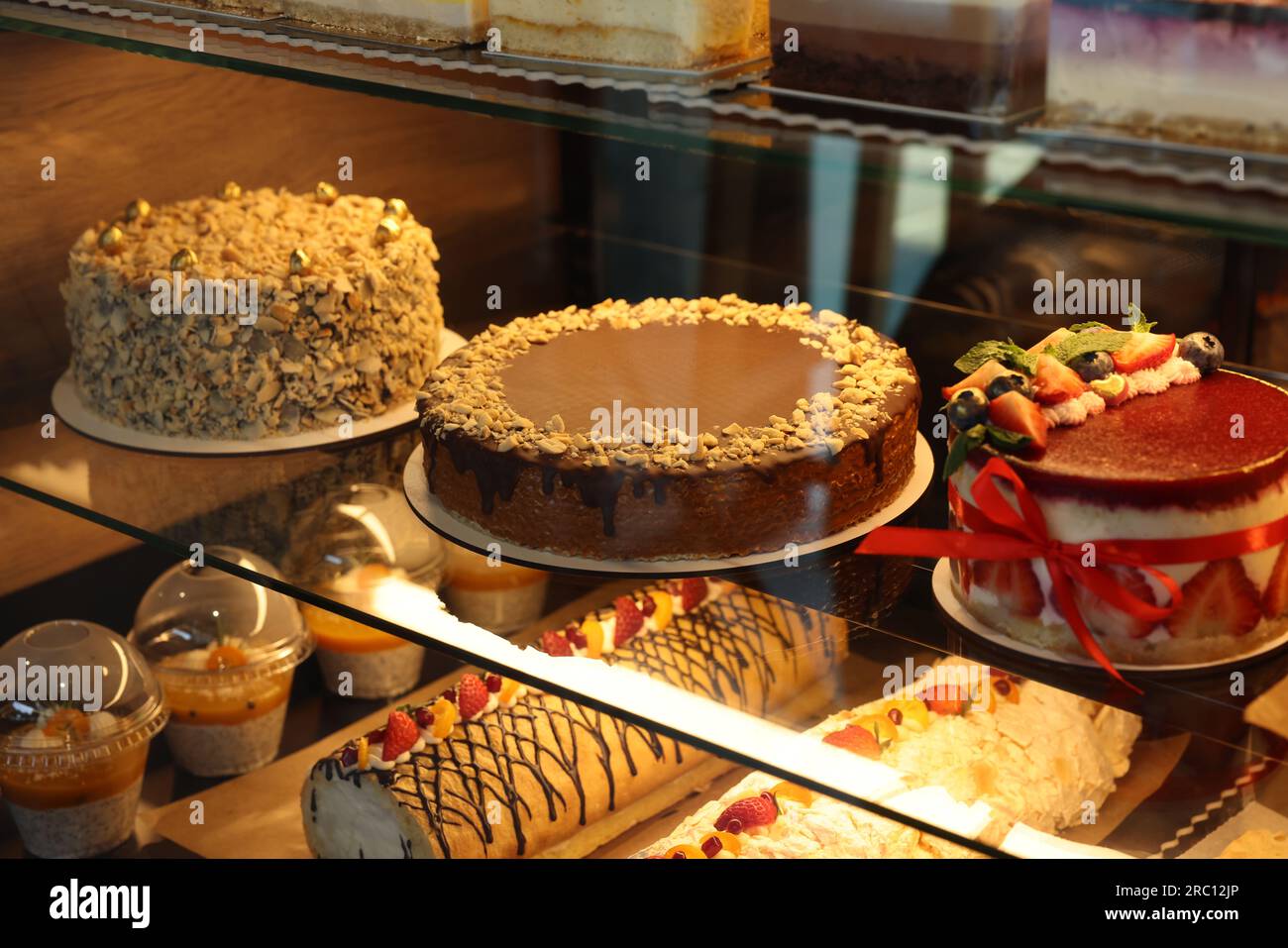 Different tasty desserts on counter in bakery shop, closeup Stock Photo ...