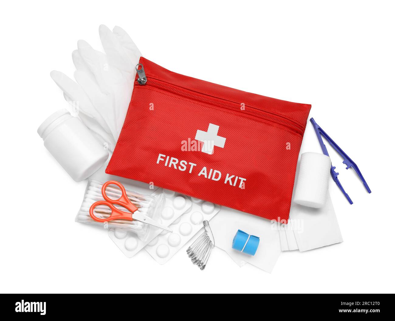 Red first aid kit, scissors, pins, gloves, cotton buds, pills, plastic ...