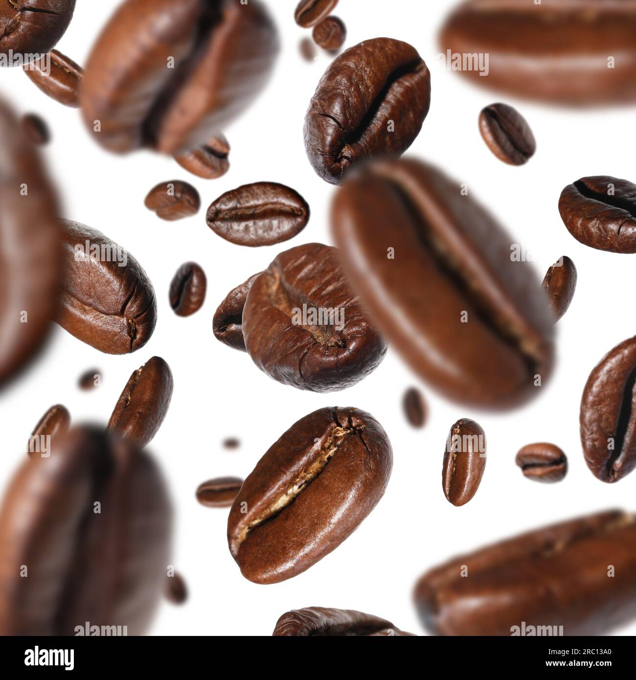 Roasted coffee beans falling o white background Stock Photo - Alamy