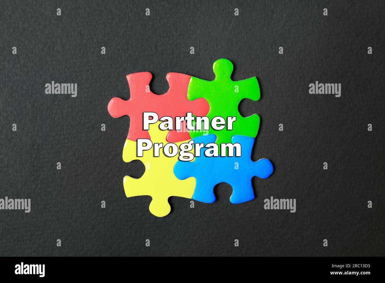 Jigsaw puzzle pieces with words Partner Program on black background ...