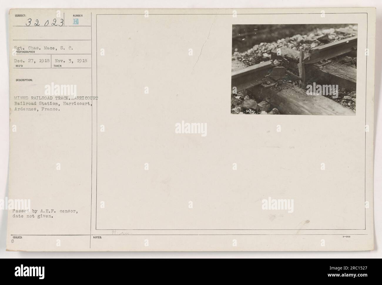 Sergeant Charles Mace is seen standing next to a mined railroad track ...
