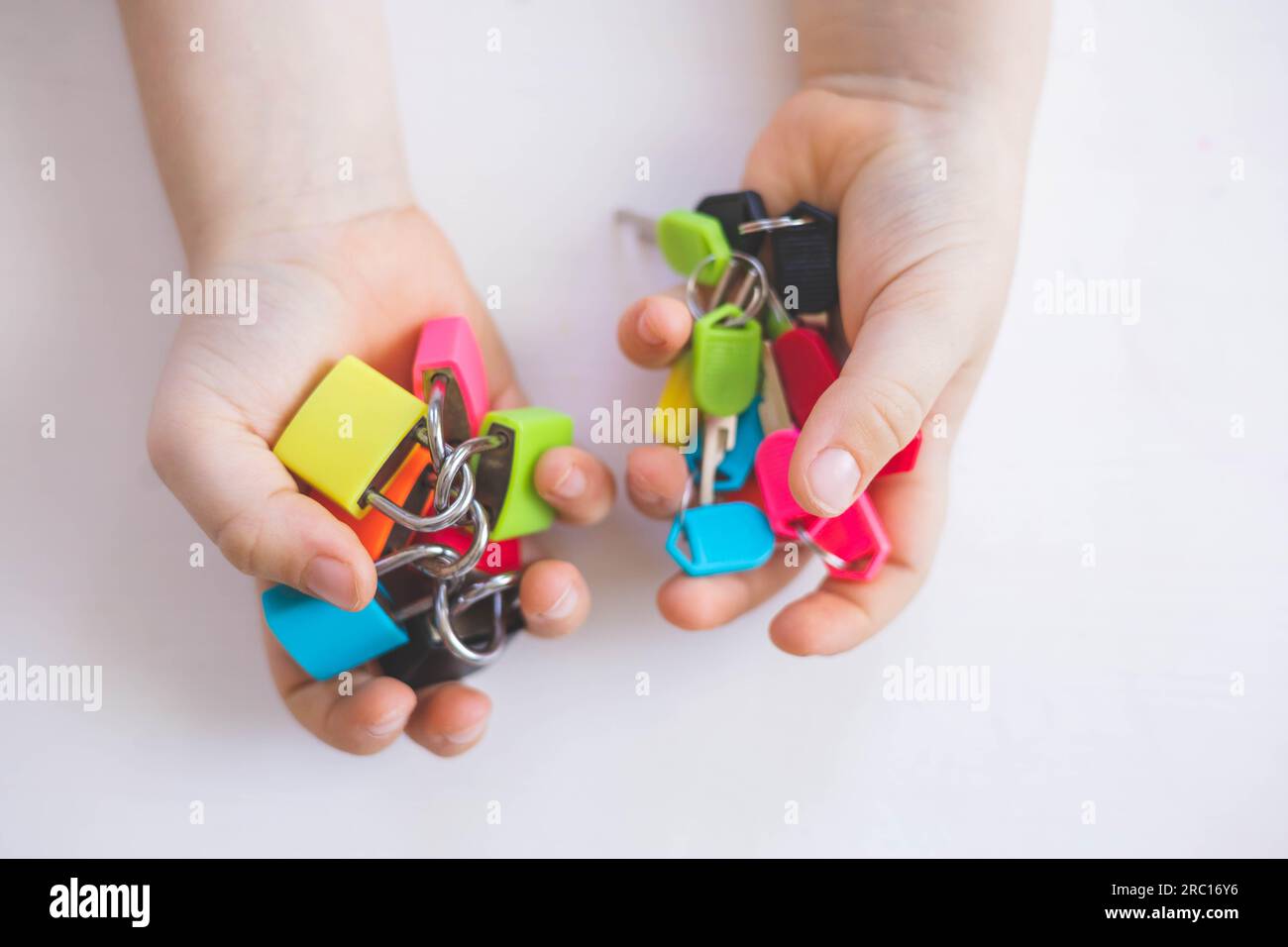 The child works with Montessori material with colored locks. Picks up ...