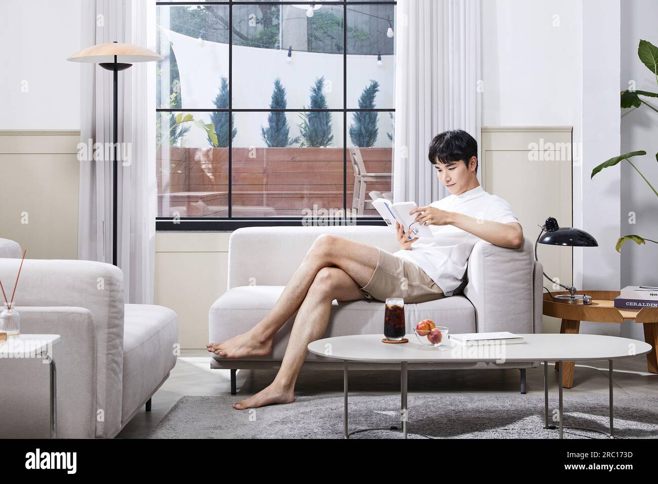 summer lifestyle, korean asian young man reading on couch Stock Photo ...