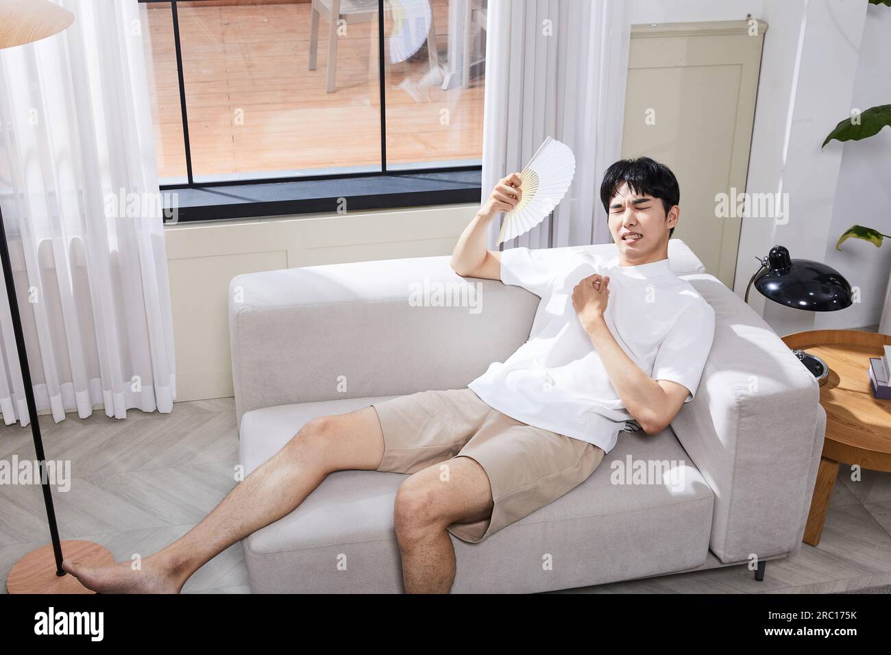 summer lifestyle, korean asian young man fanning Stock Photo - Alamy