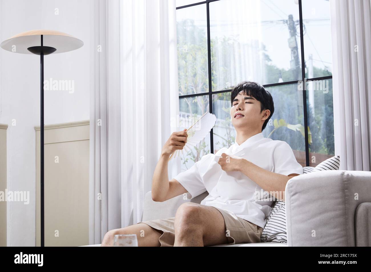 summer lifestyle, korean asian young man fanning Stock Photo - Alamy