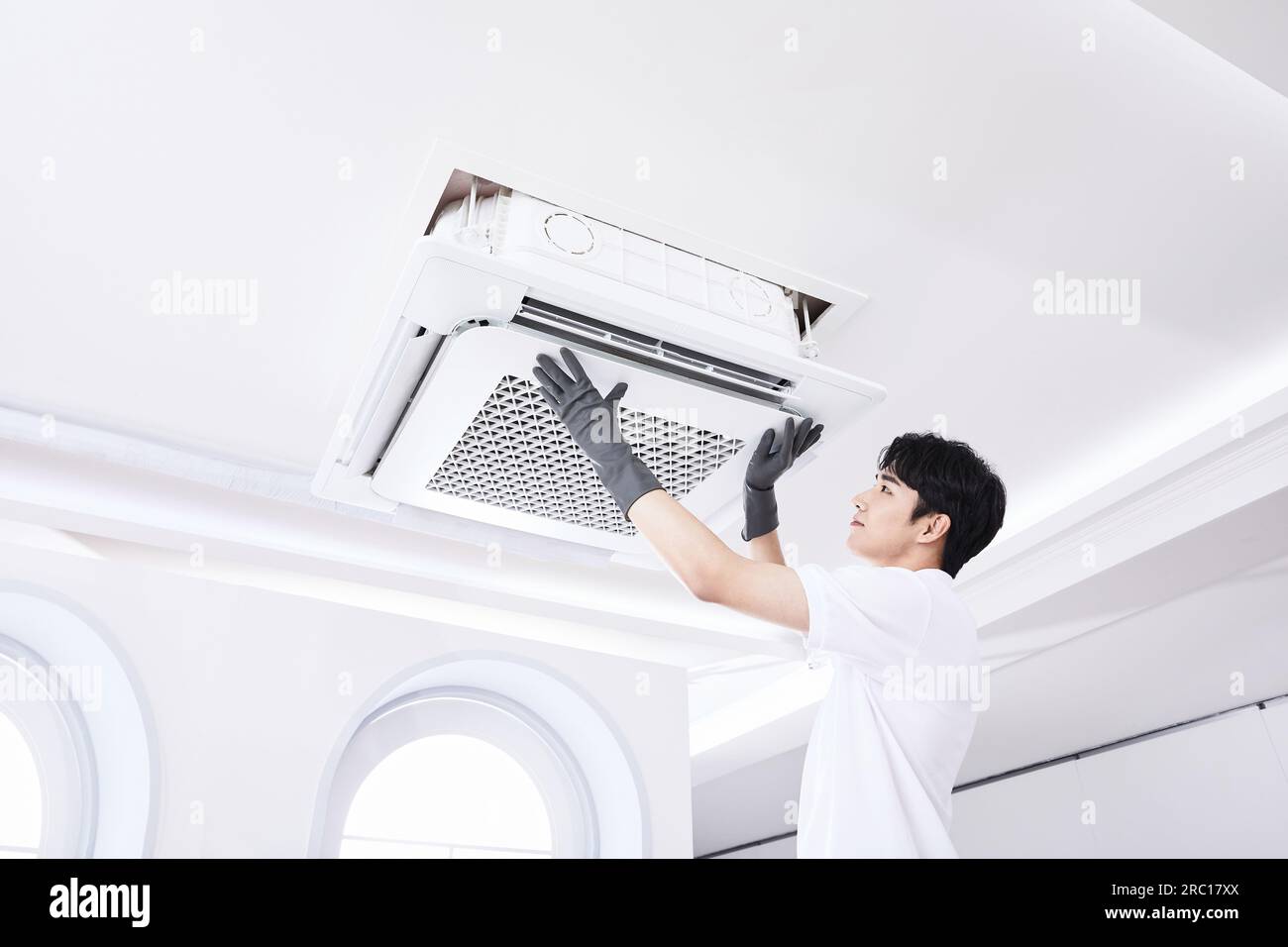 summer lifestyle, korean asian young man assembling air conditioner ...