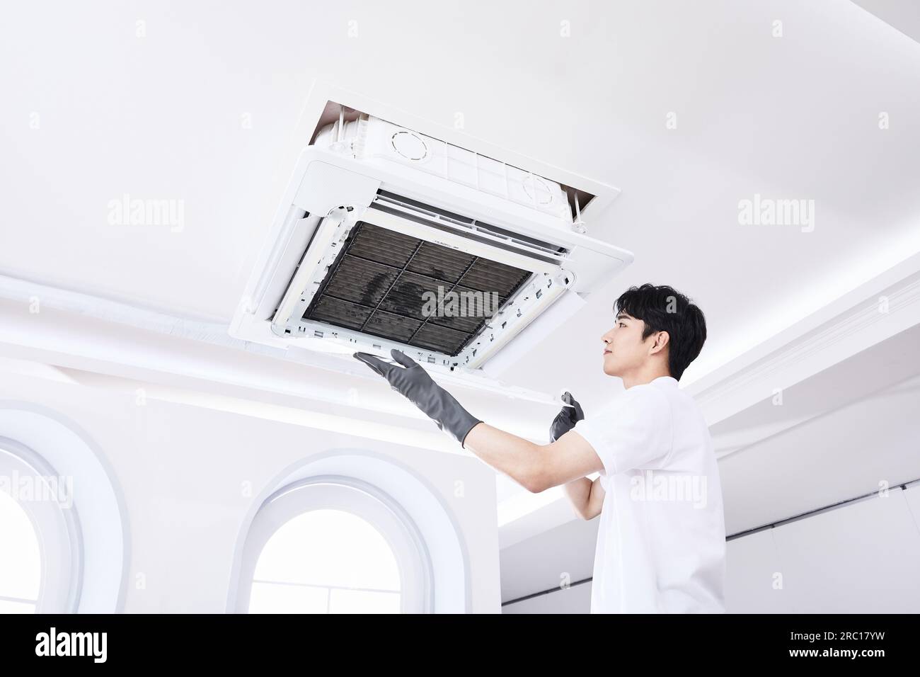summer lifestyle, korean asian young man assembling air conditioner ...