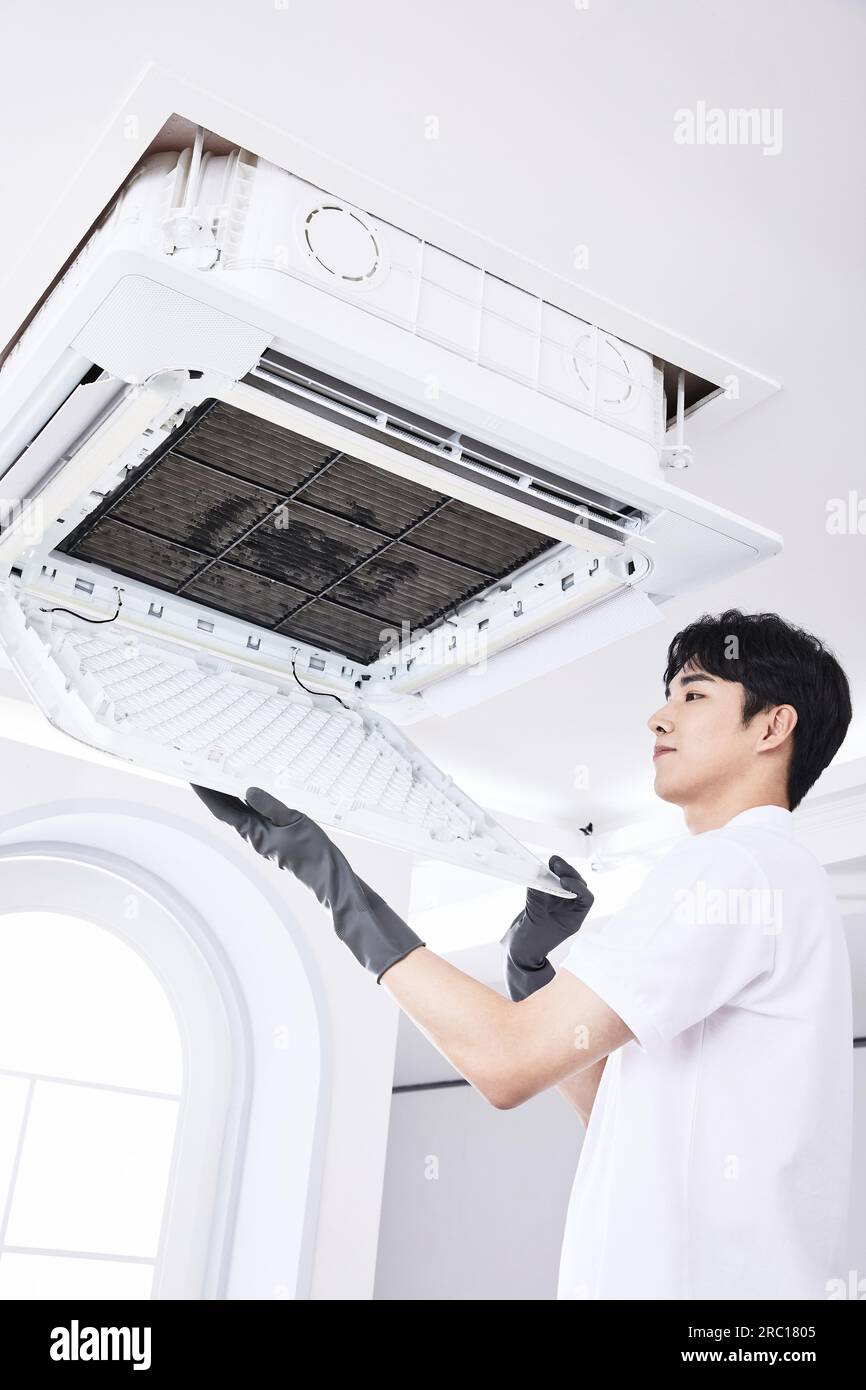 summer lifestyle, korean asian young man assembling air conditioner ...
