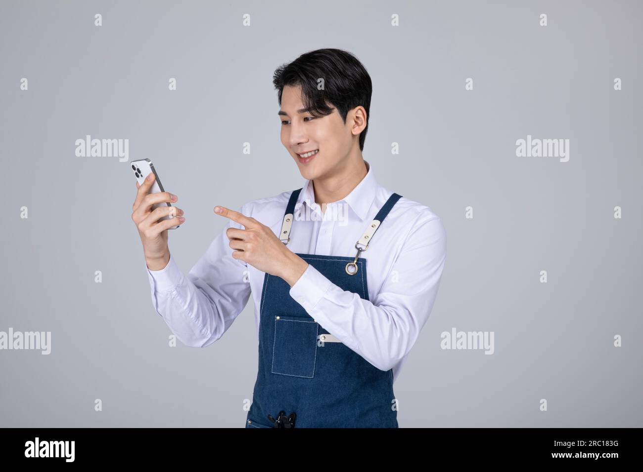 millennials and gen z, korean asian young man holding a smartphone ...