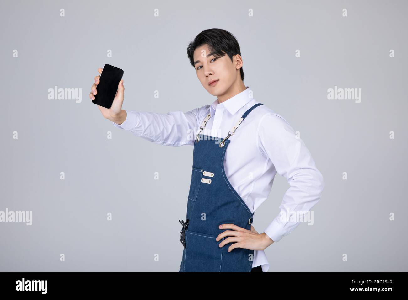 millennials and gen z, korean asian young man holding a smartphone ...