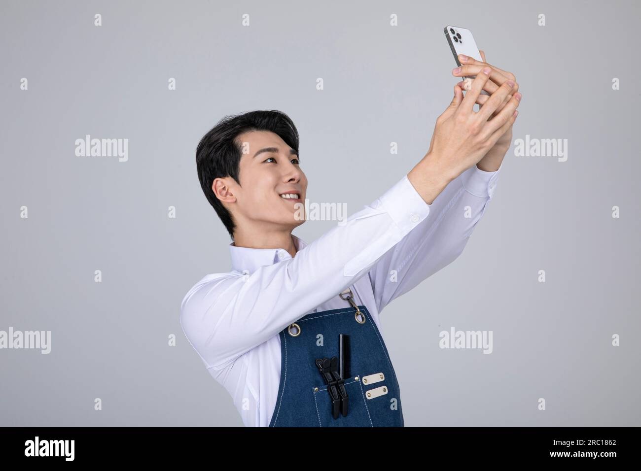 millennials and gen z, korean asian young man holding a smartphone ...